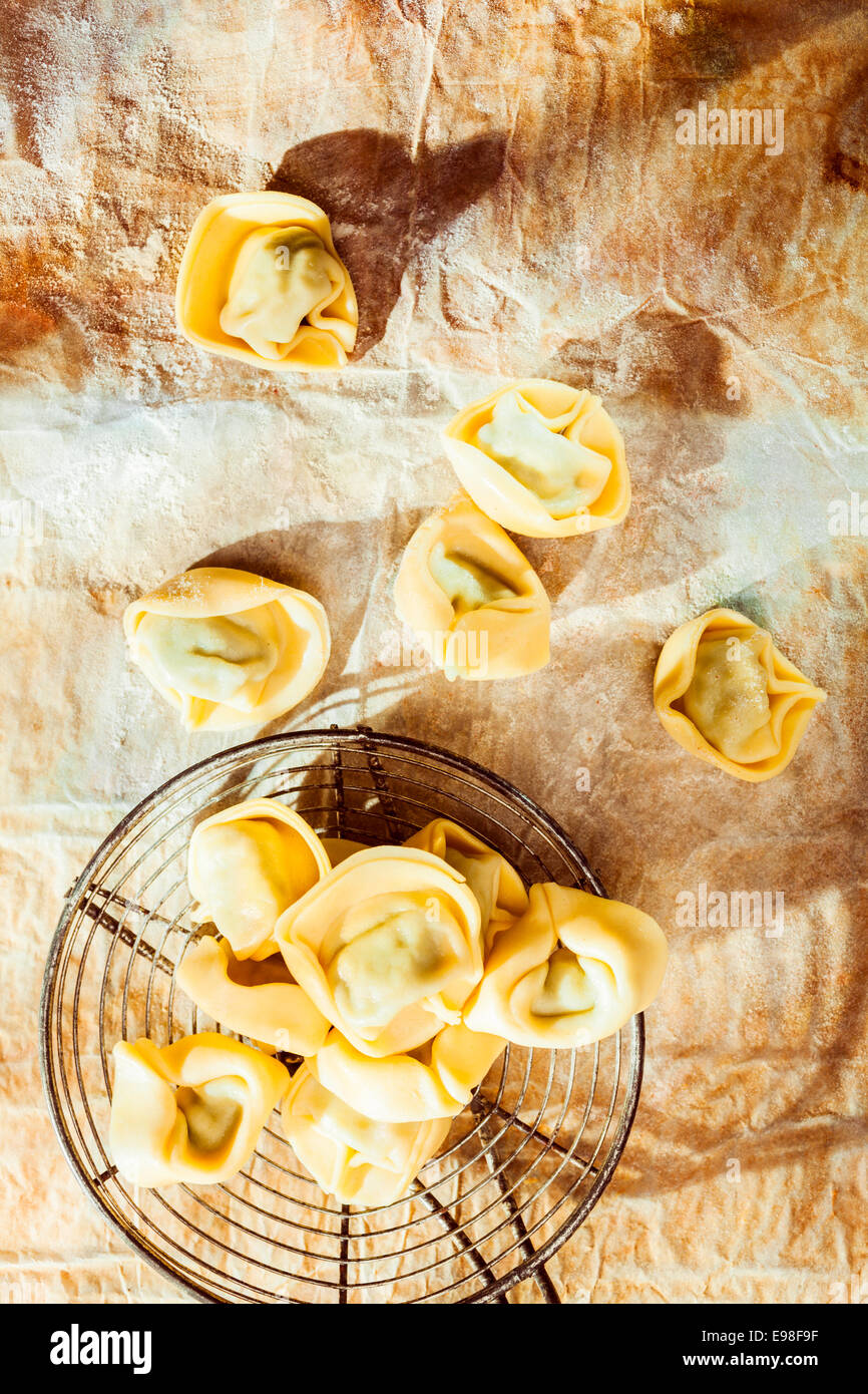 Preparing a meal of traditional Italian tortellini pasta with a savory ...