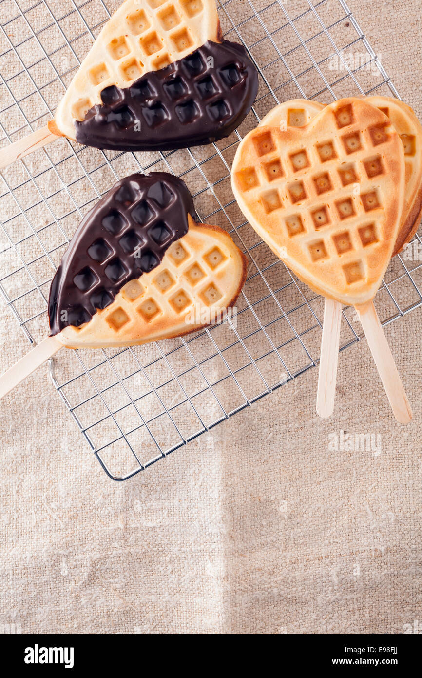 Romantic heart shaped waffle lollipops with a crisp golden wafer dipped ...