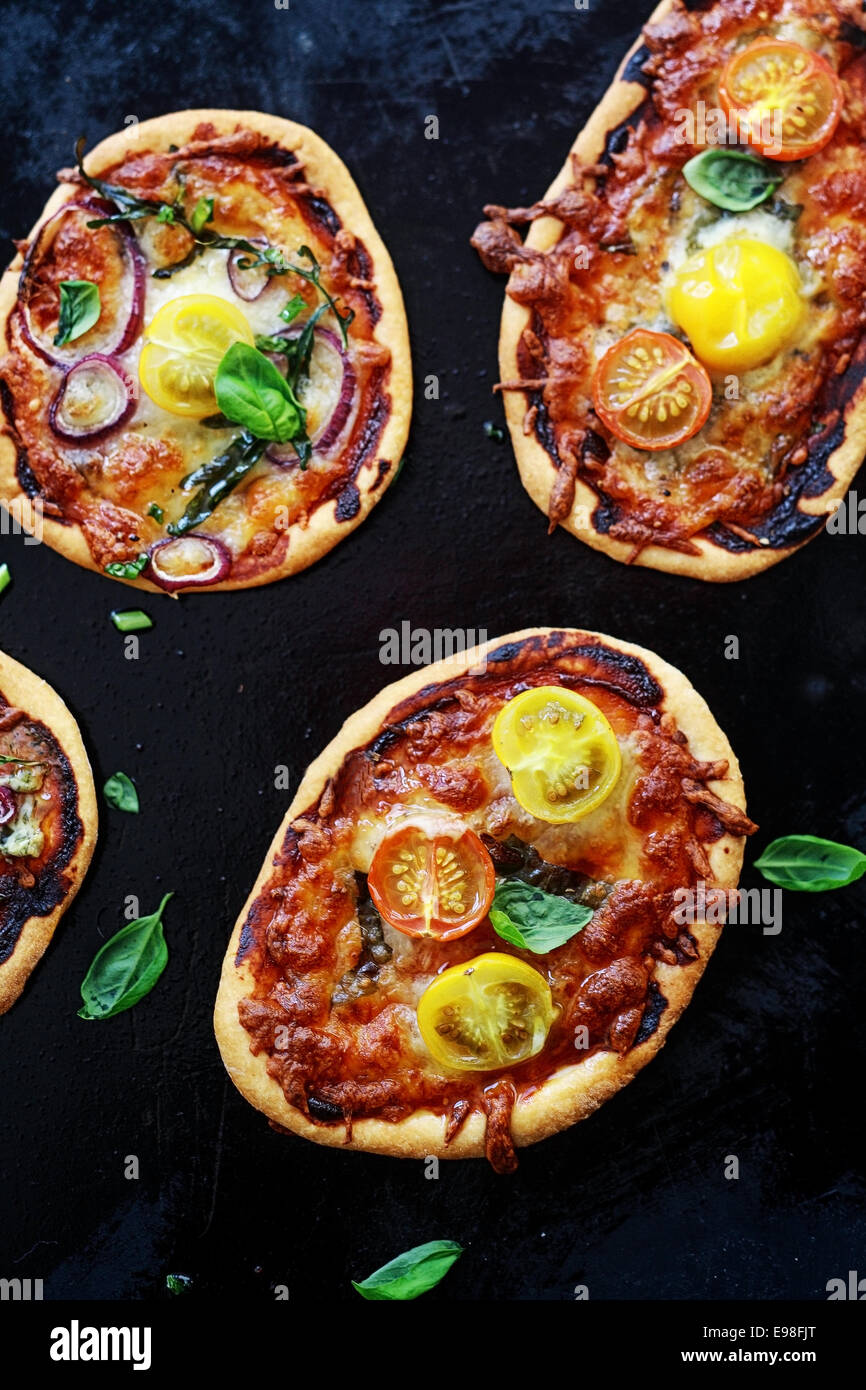 Savory mini Italian pizzas with cheese and tomato or onion, cheese and ...