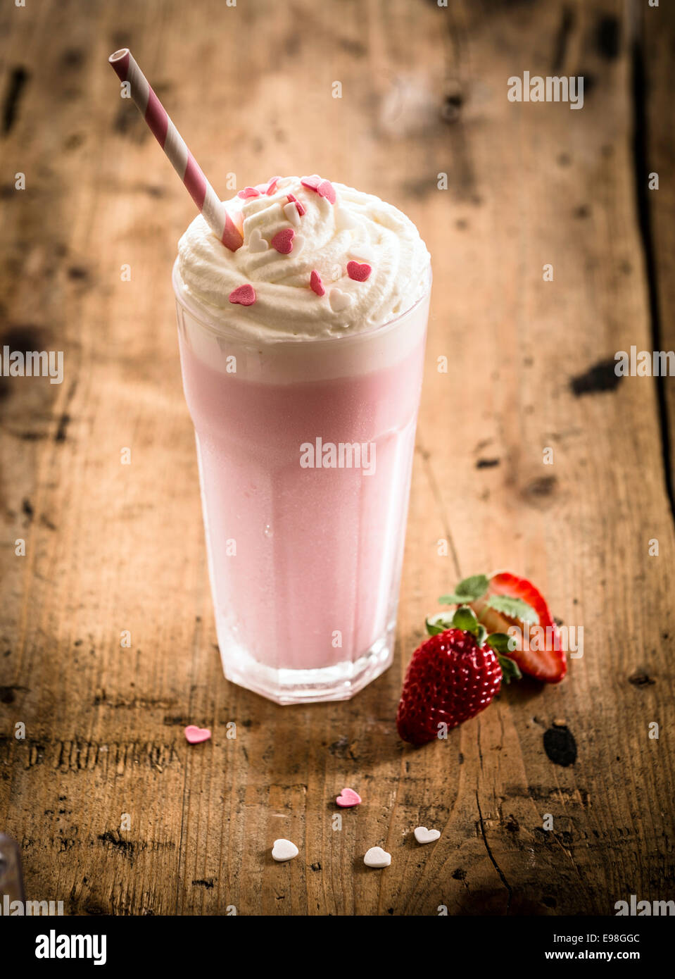 Berry smoothie or milkshake in a tall glass made from a blend of fresh ...