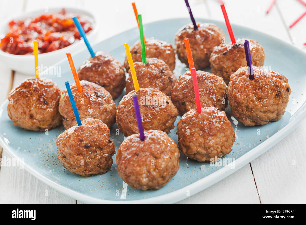 Buffet display of tasty spicy meatballs with colorful toothpicks for ...