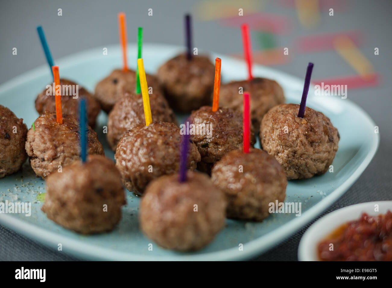 Plate of tasty spicy savoury meatballs for party snacks with colorful ...