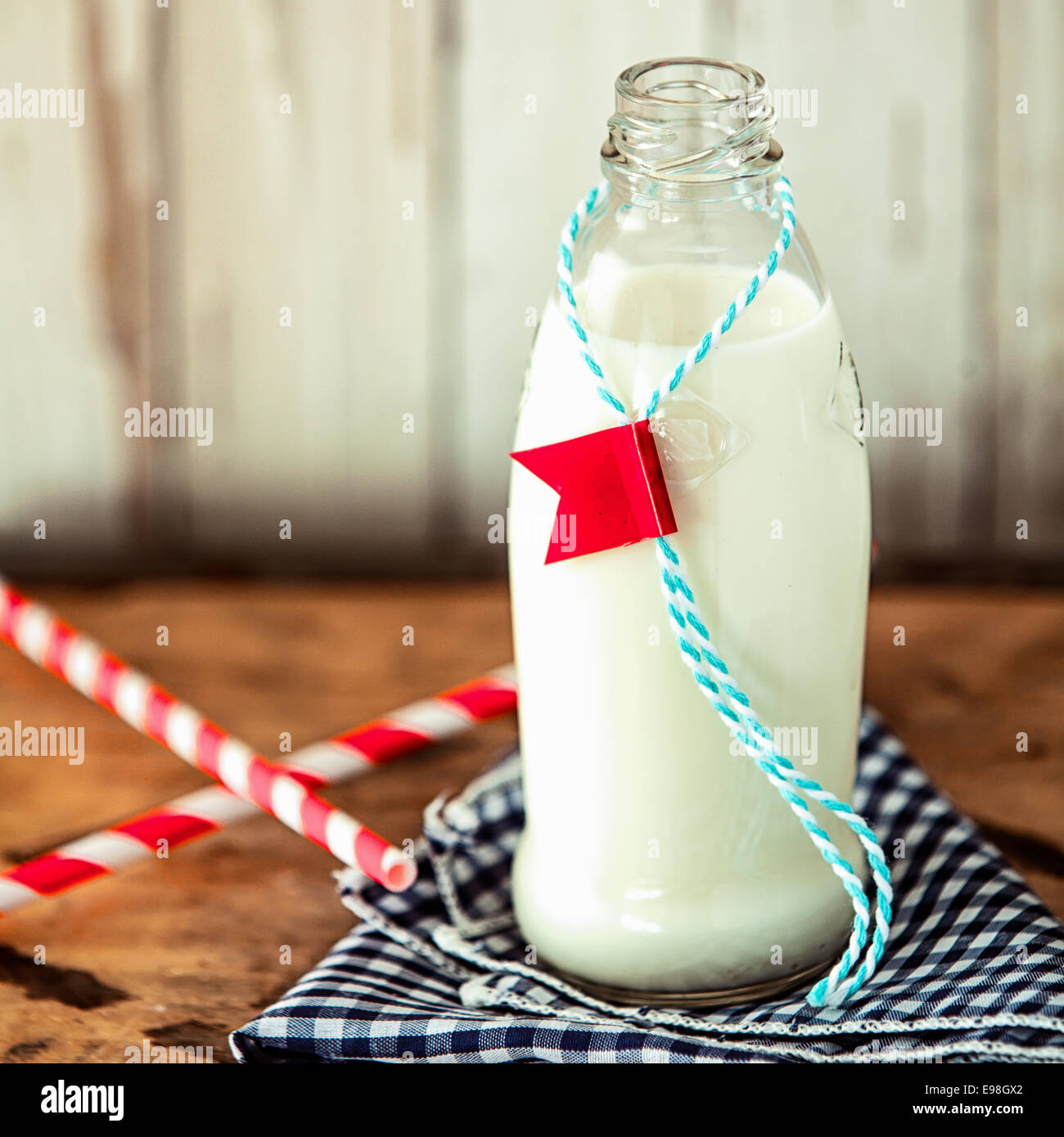 Glass bottle of fresh full cream farm milk with a label attached on a ...