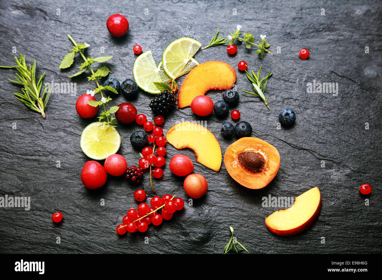 Scattered fresh fruit and berries with cranberries, blackberries ...