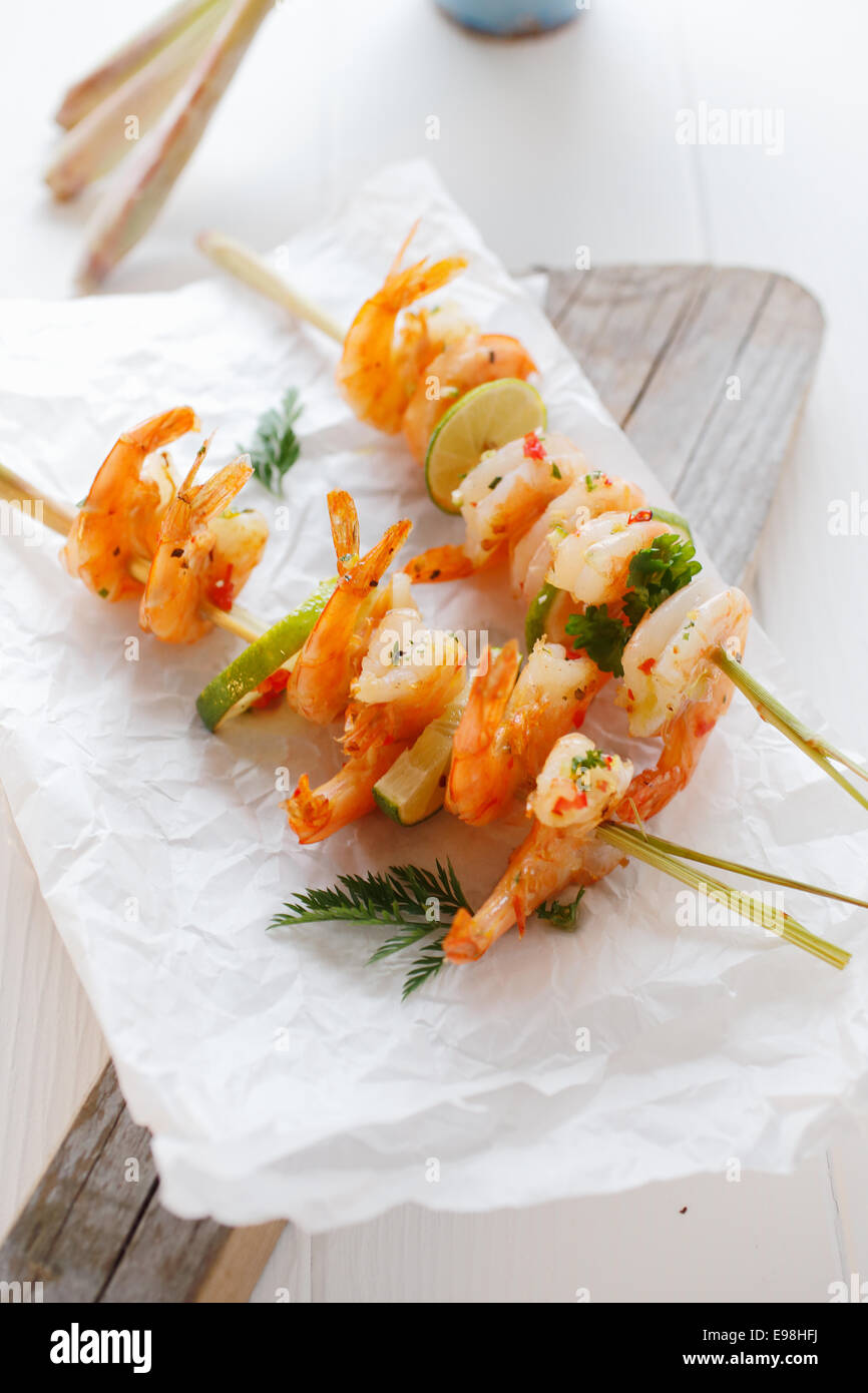 Two delicious gourmet seafood kebabs with pink prawns , fresh herbs and ...