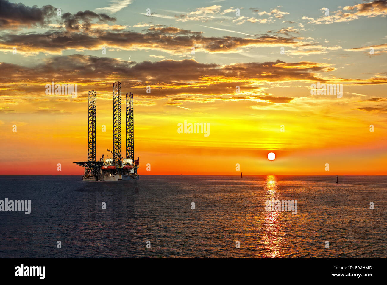 Oil drilling rig in sunset time Stock Photo - Alamy