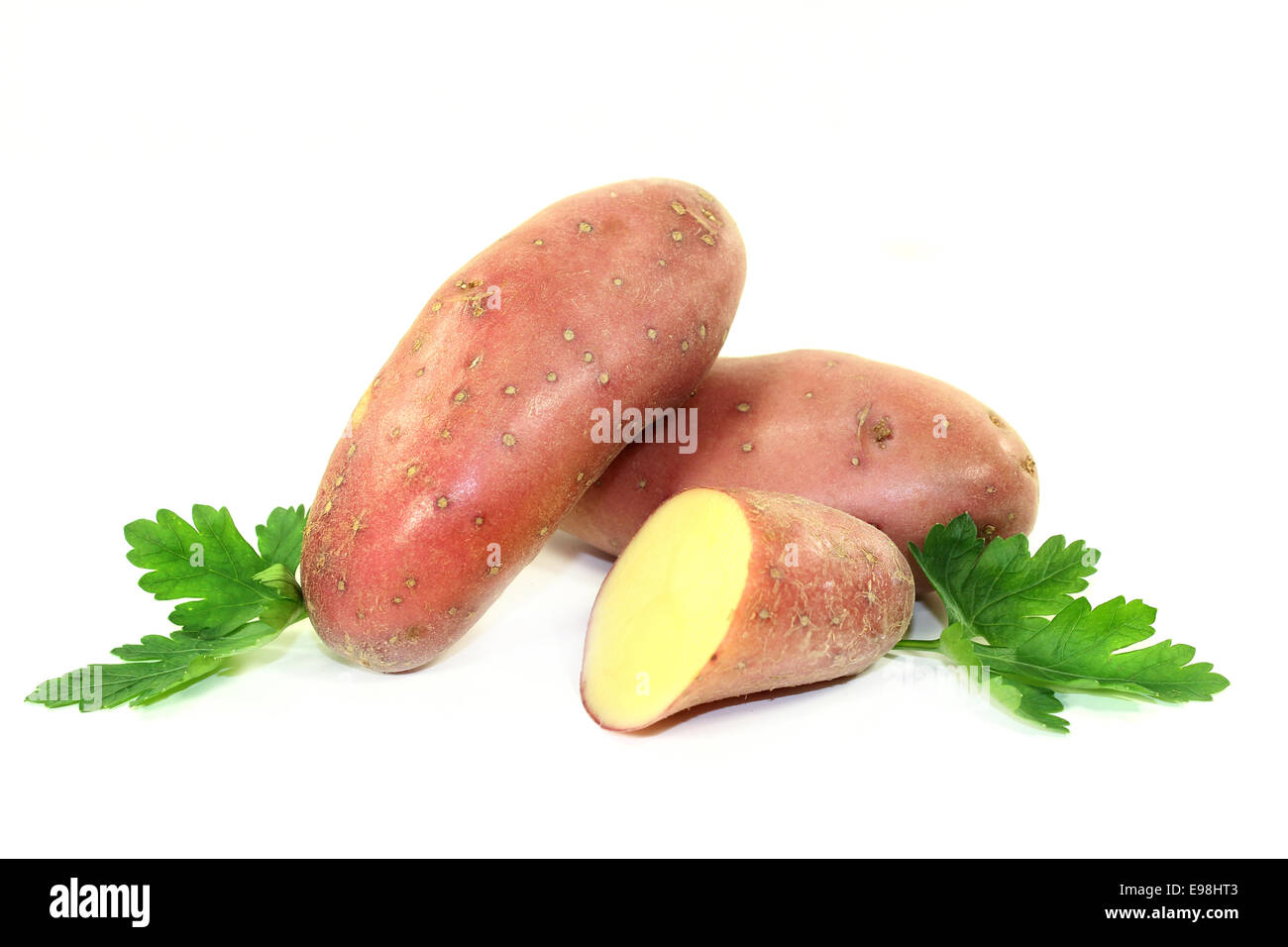 raw, red potatoes on a white background Stock Photo - Alamy