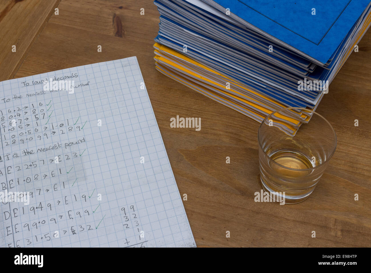 Primary school books waiting to be marked Stock Photo - Alamy