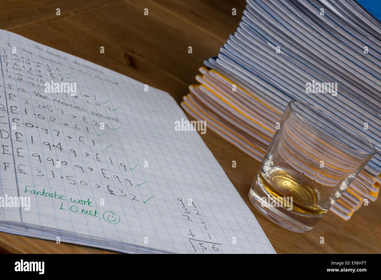 Primary school books waiting to be marked Stock Photo - Alamy