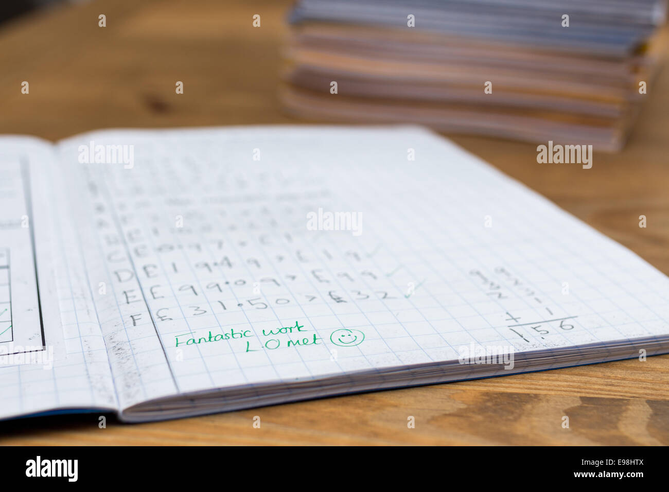 Primary school books waiting to be marked Stock Photo - Alamy