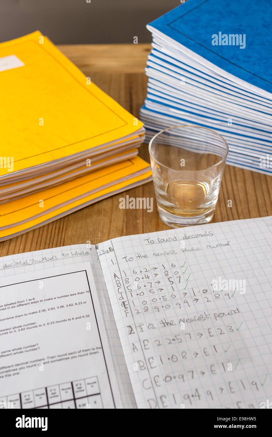 Primary school books waiting to be marked Stock Photo - Alamy