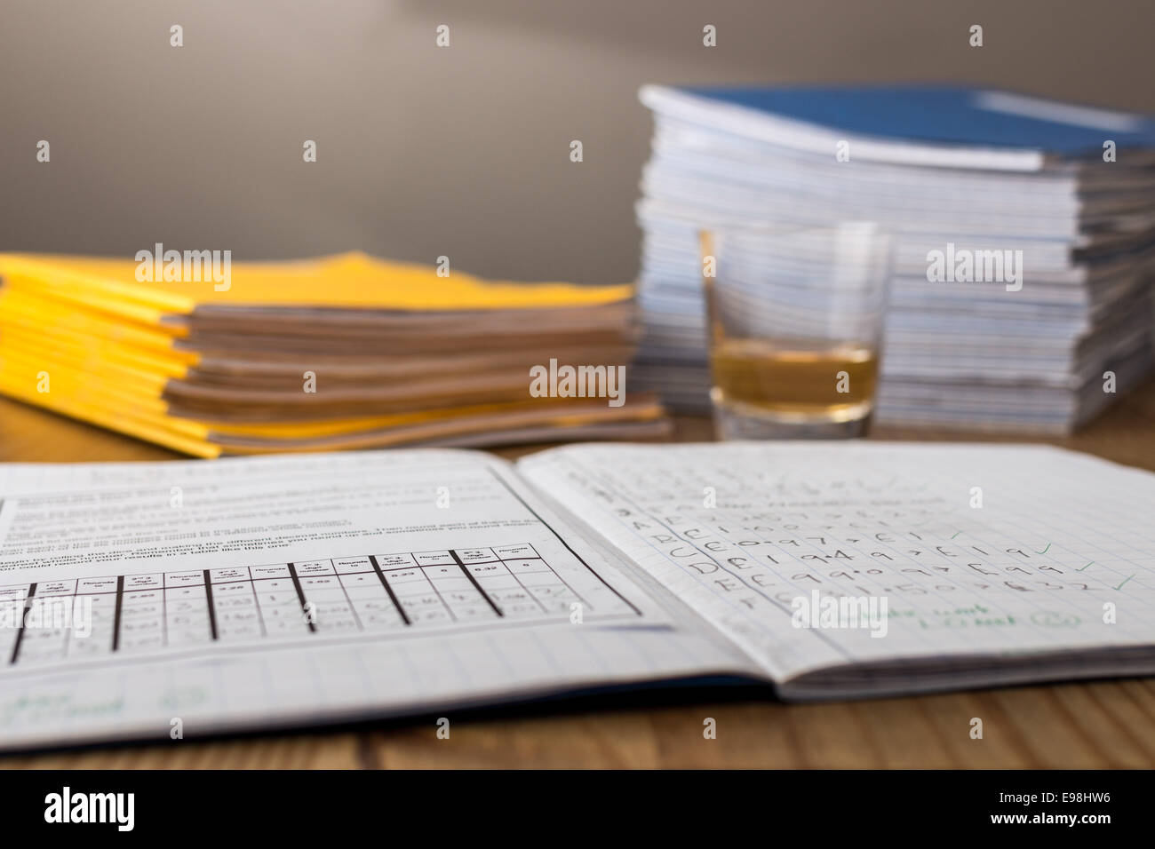 Primary school books waiting to be marked Stock Photo - Alamy