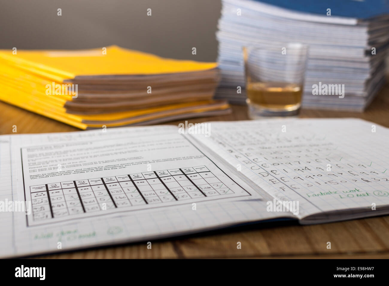 Primary school books waiting to be marked Stock Photo - Alamy