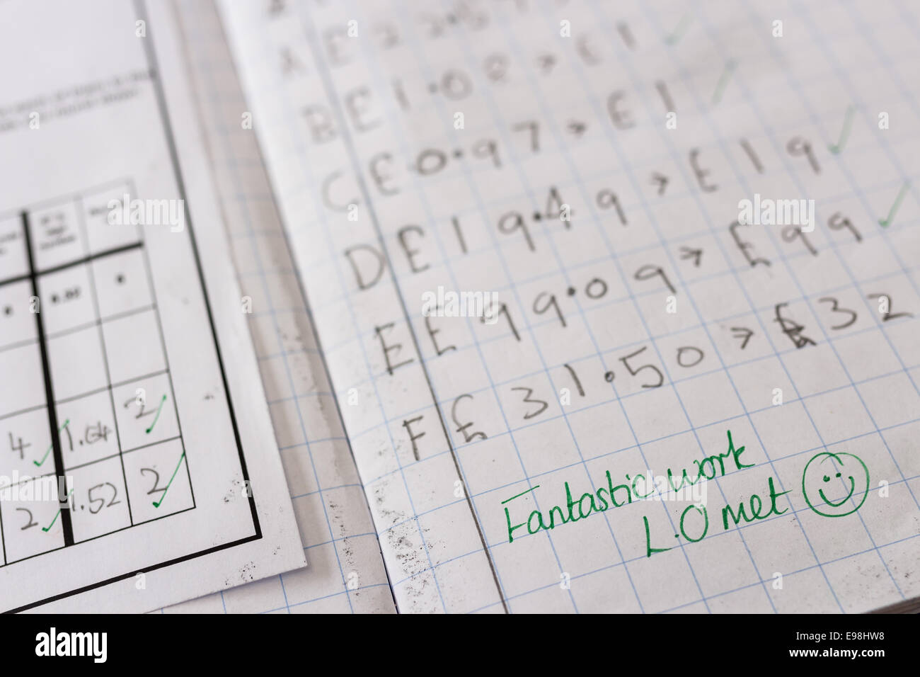 Primary school books waiting to be marked Stock Photo - Alamy