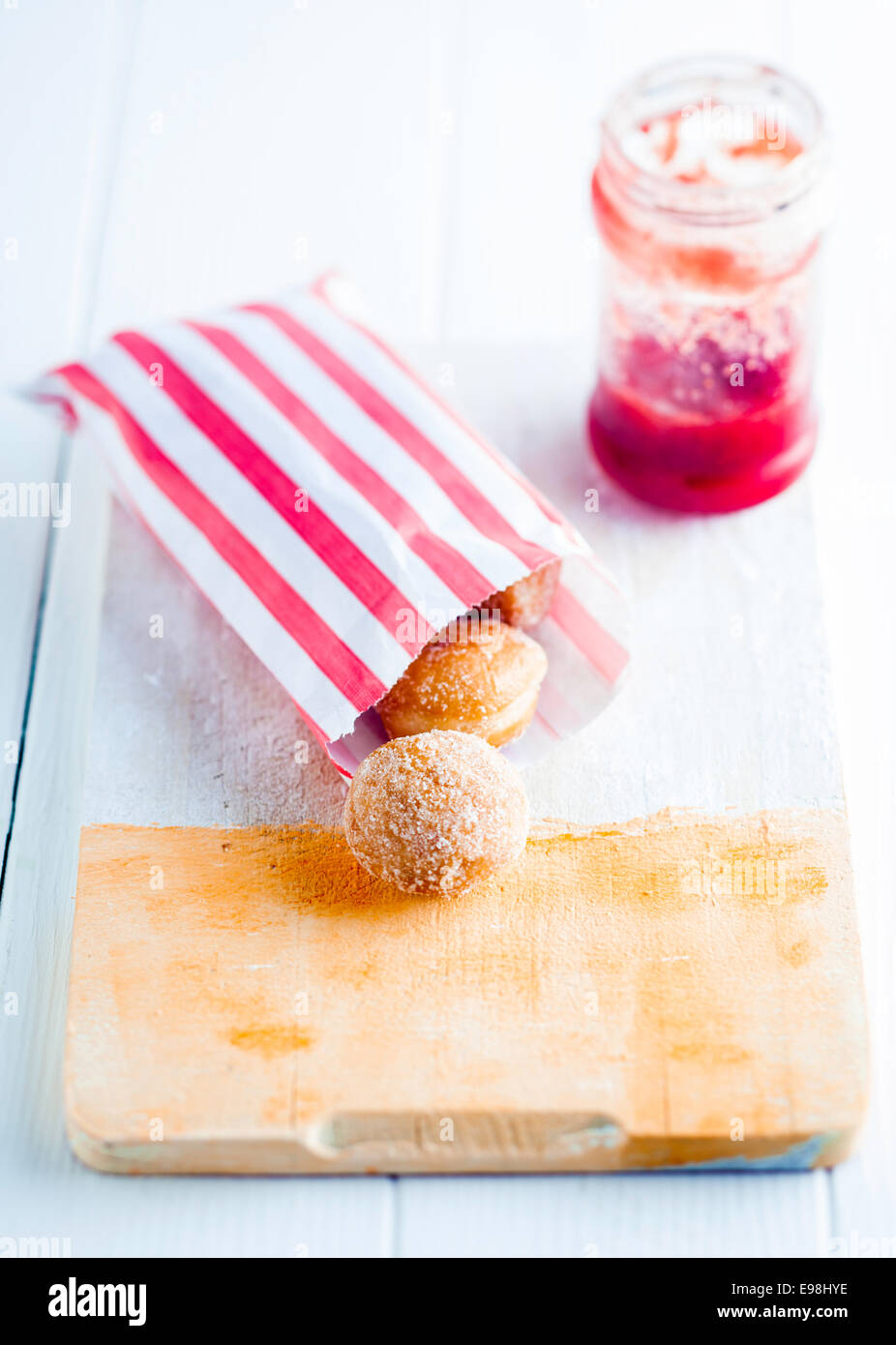 Colorful striped red and white paper takeaway packet of fresh sugared ...