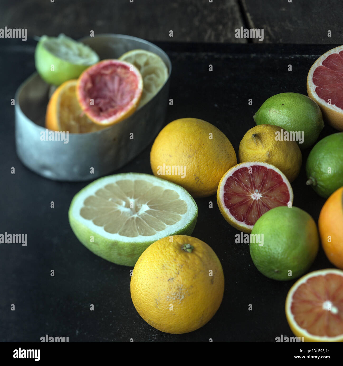Juicing a selection of fresh citrus fruit with grapefruit, oranges ...