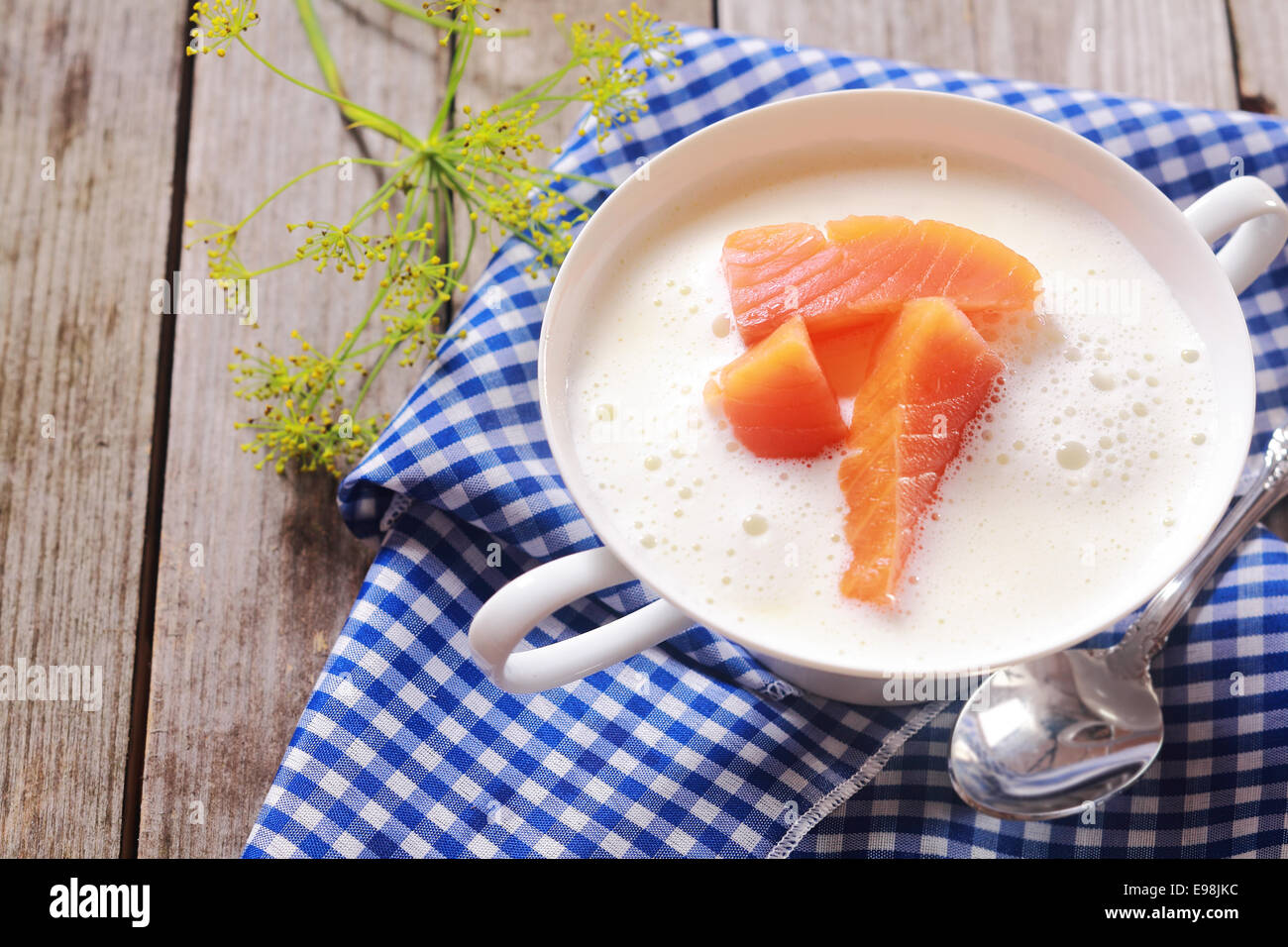 Gourmet fresh salmon chowder soup with pieces of raw salmon fillet in a ...