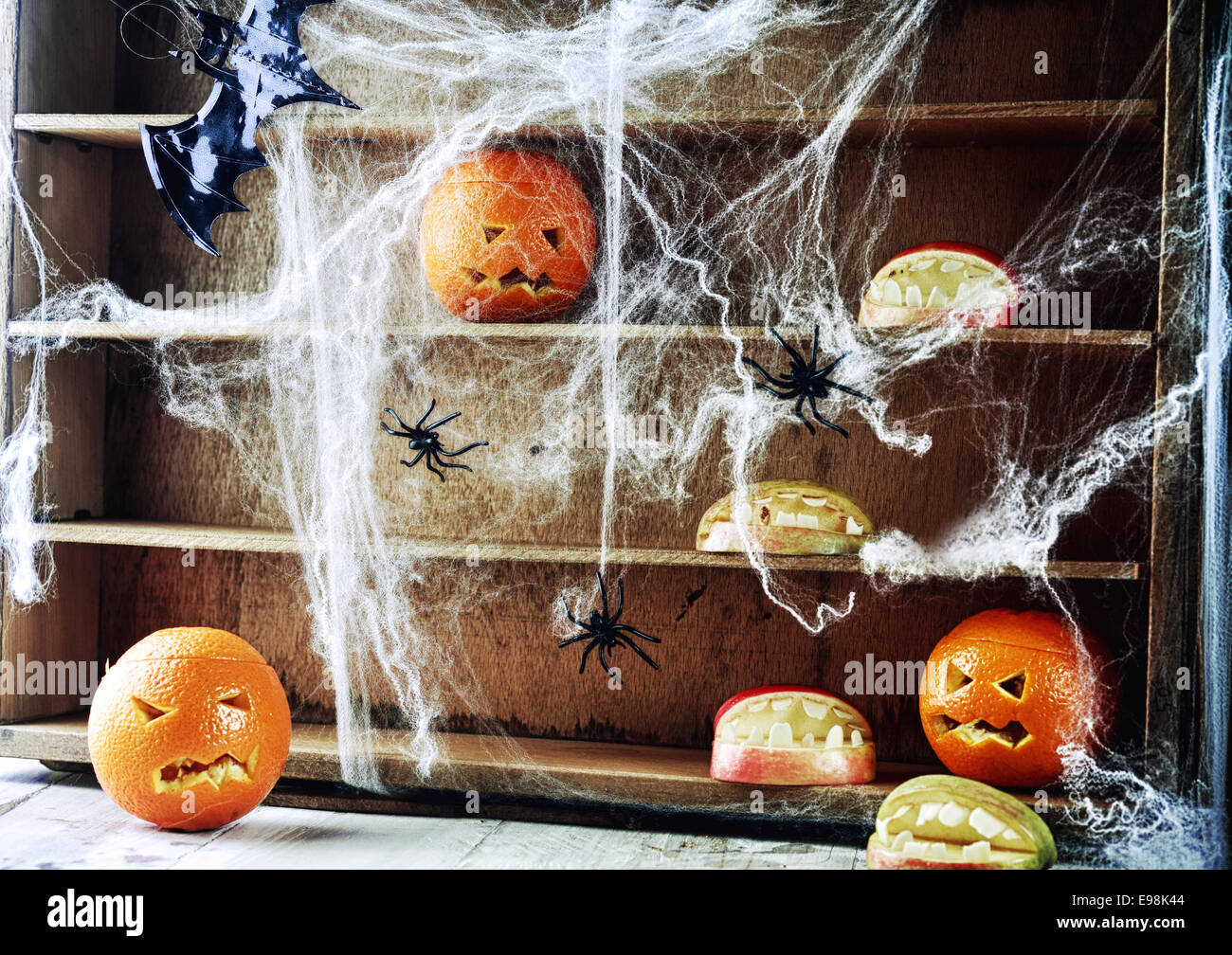 Spooky Halloween pantry with pumpkin lanterns and apples shaped as open ...