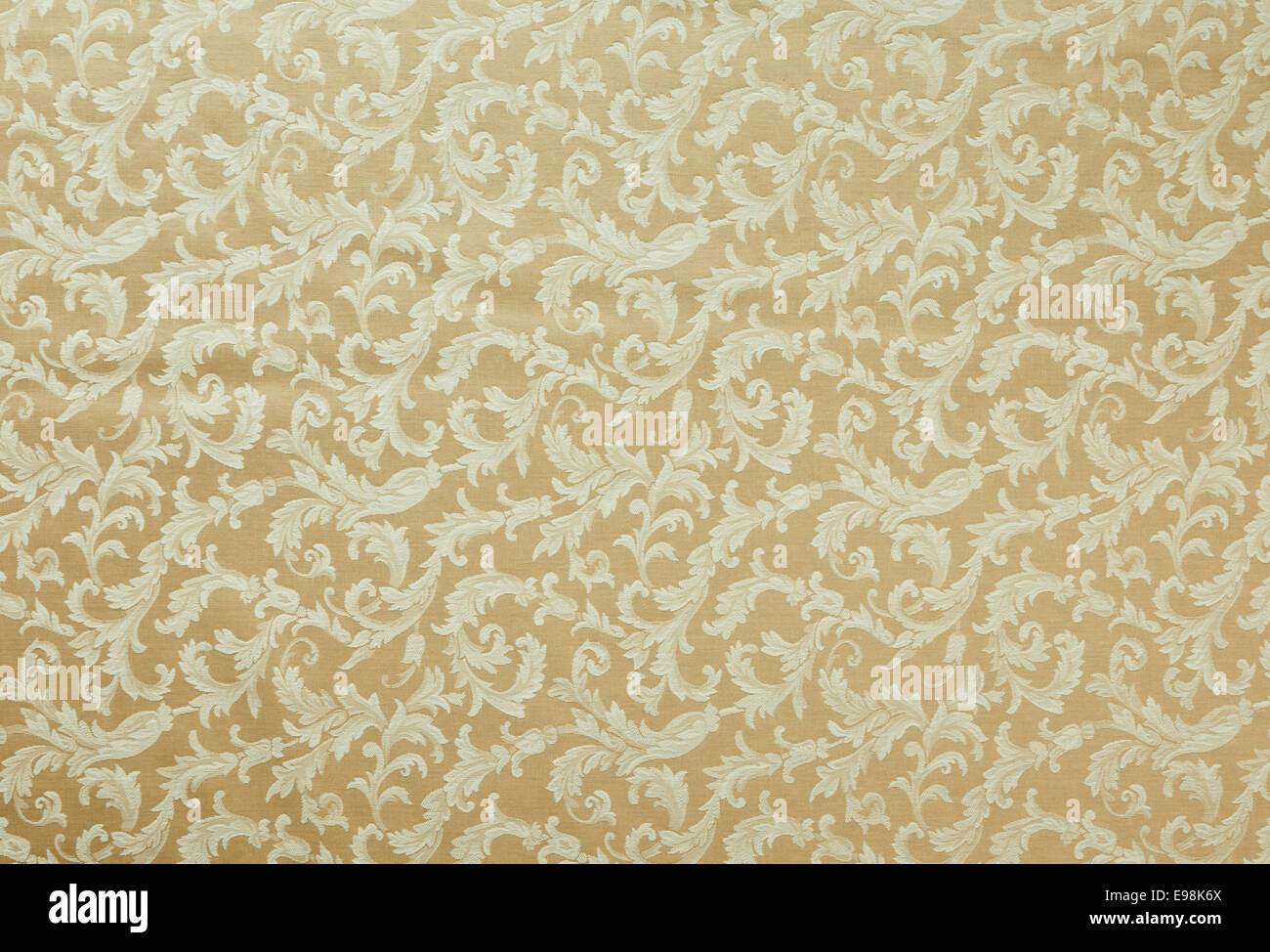 Abstract background of a heavy beige brocade fabric with interwoven ...