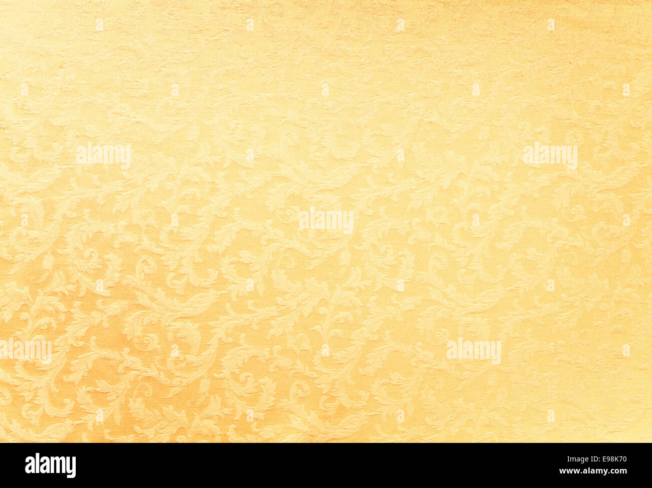 Abstract background of a heavy golden brocade fabric with interwoven ...