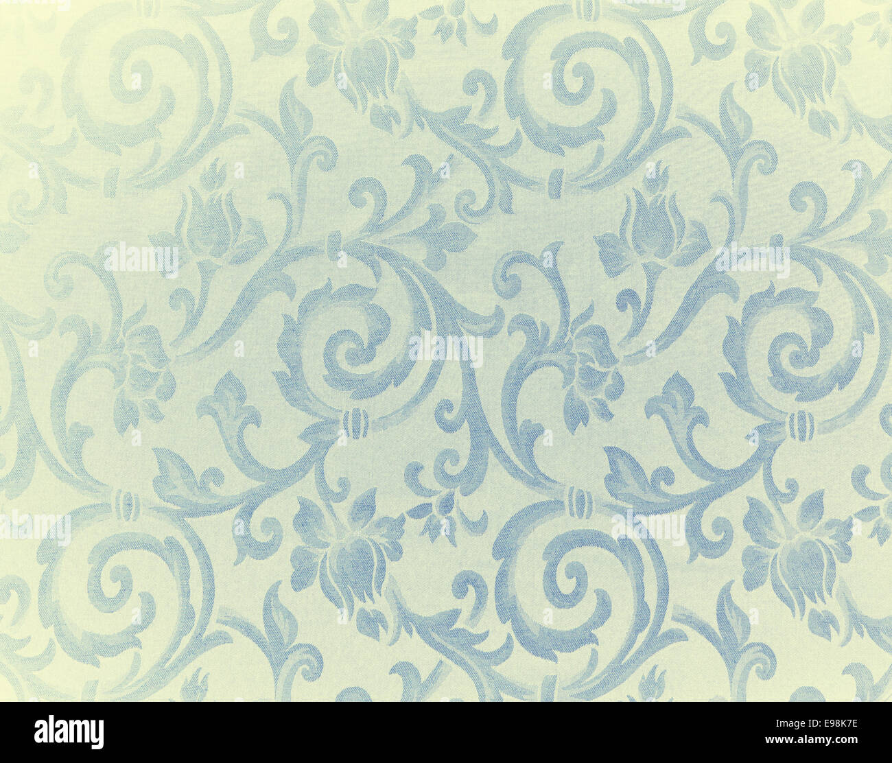 Abstract background of a heavy light yellow and blue brocade fabric ...