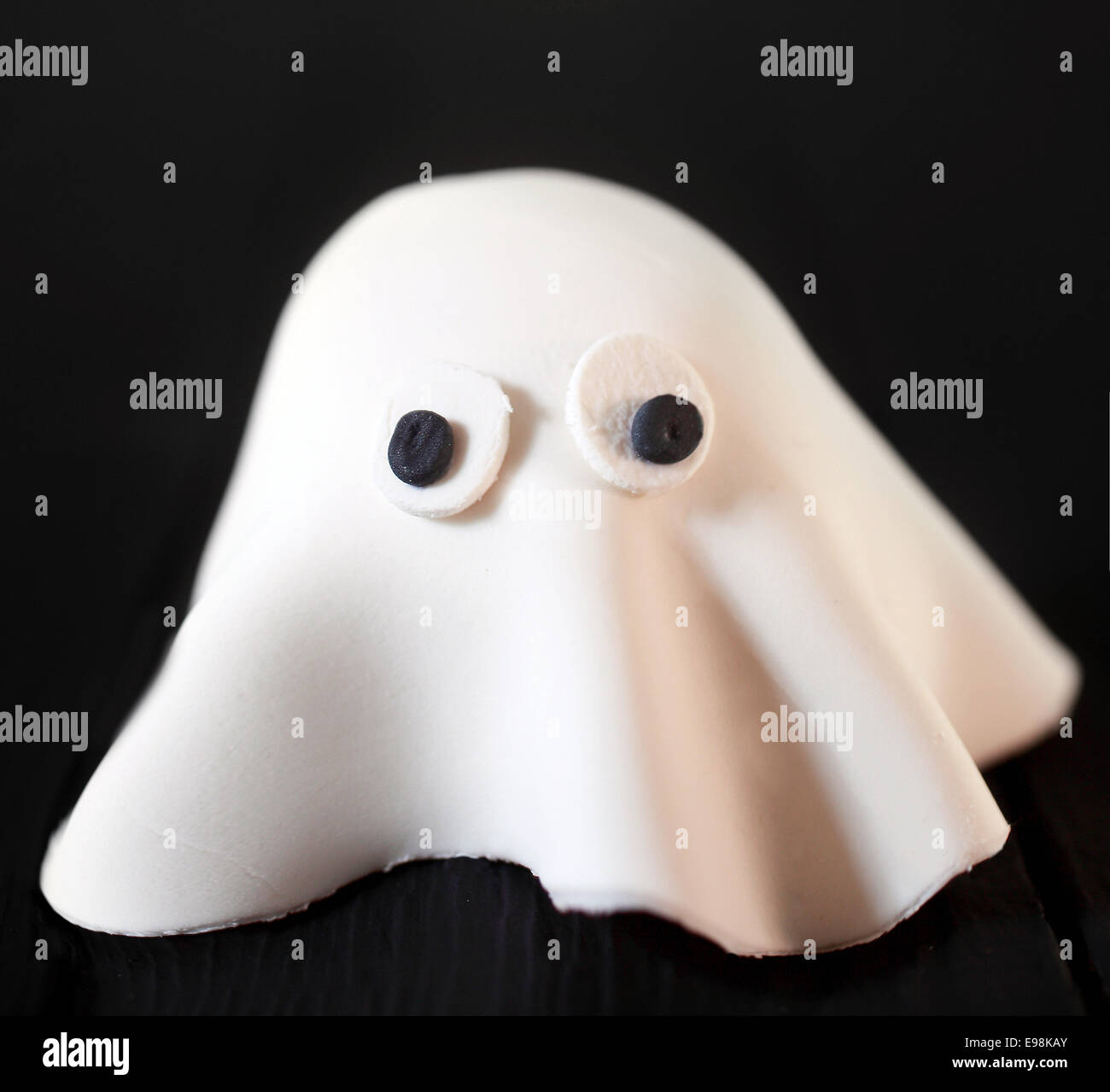 Cute scary white Halloween ghost made of pastry dough with large eyes ...