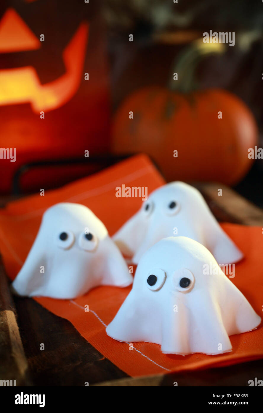 Homemade pastry dough Halloween ghosts in a rustic festive background ...