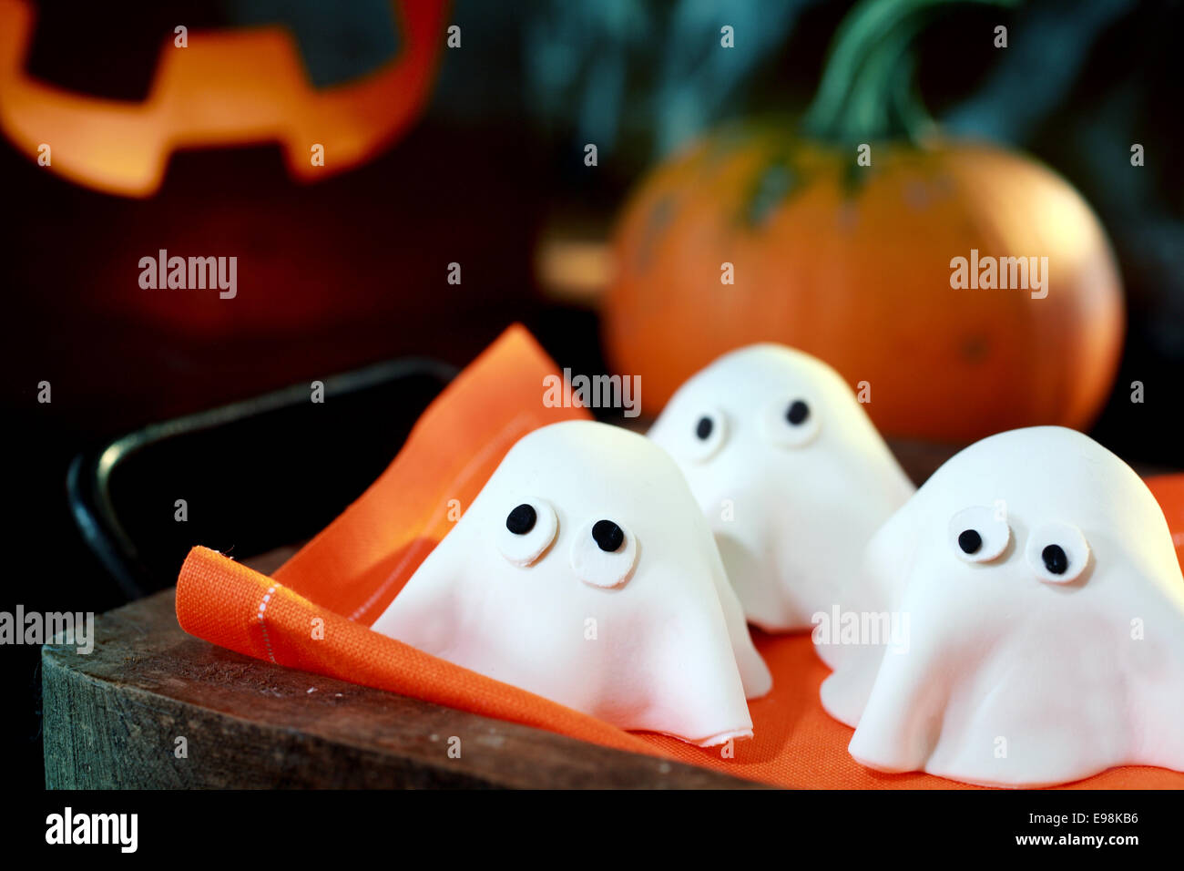 Tray of cute little Halloween monsters or ghosts made of pastry dough ...