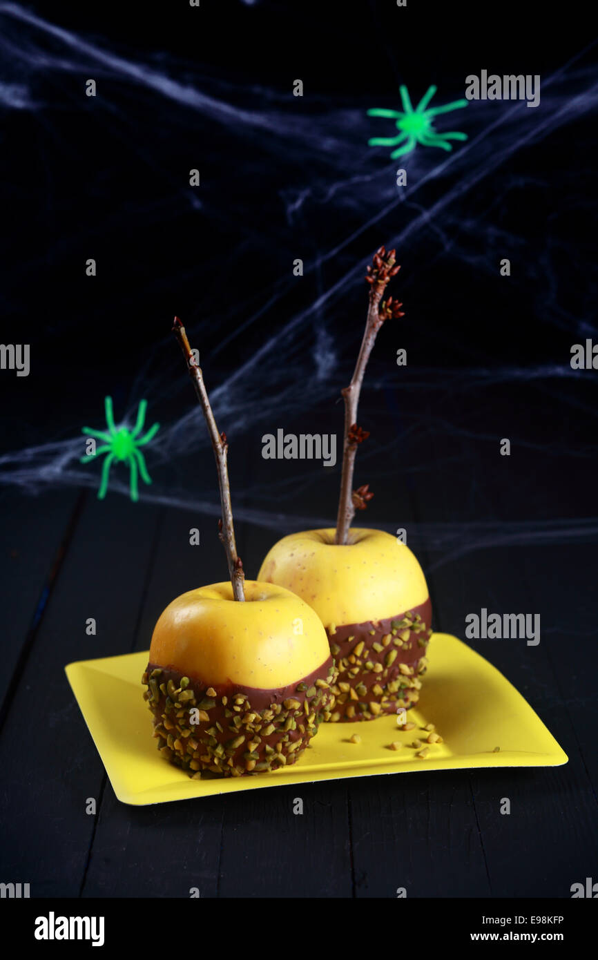 Creepy Halloween dessert of dipped chocolate apples festooned in spider ...