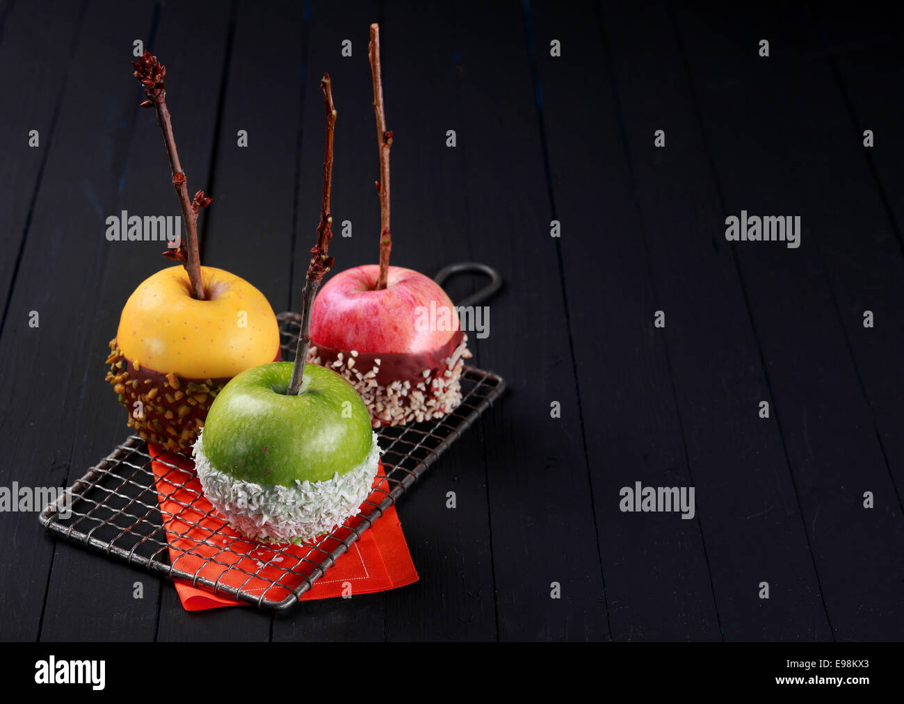 Trio of colorful Halloween apple desserts in red, green and yellow ...
