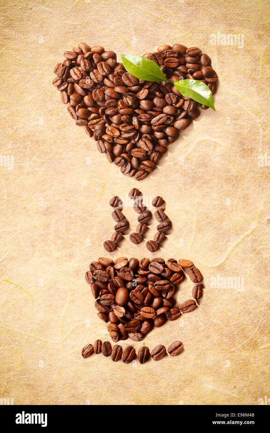 Hot Coffe Cup and a heart shape figured with coffee beans Stock Photo ...