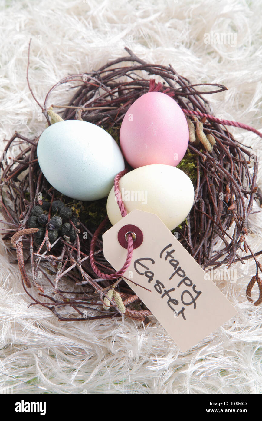 Three Easter Eggs in a nest with a handwritten Happy Easter sign Stock ...