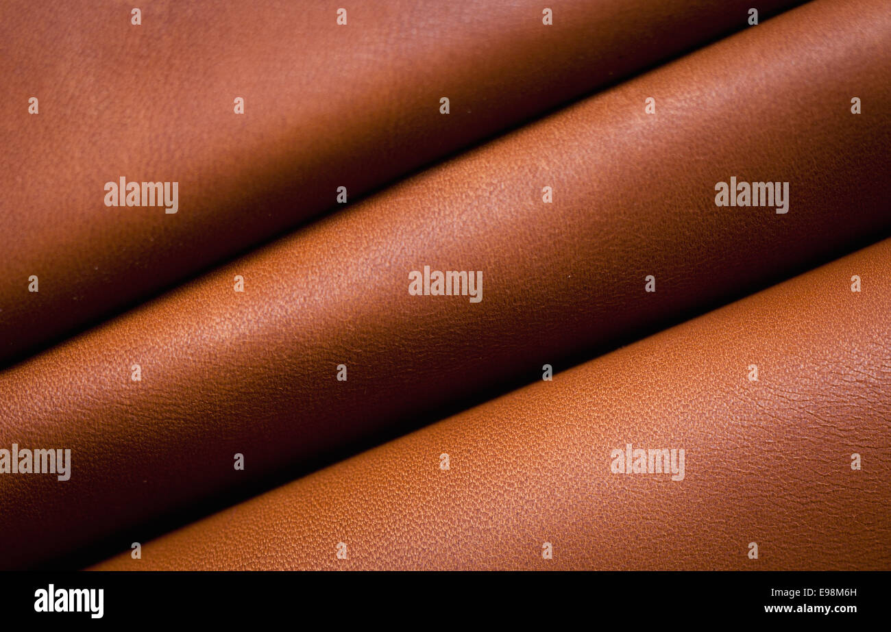 Abstract background of diagonally folded brown textured leather Stock ...