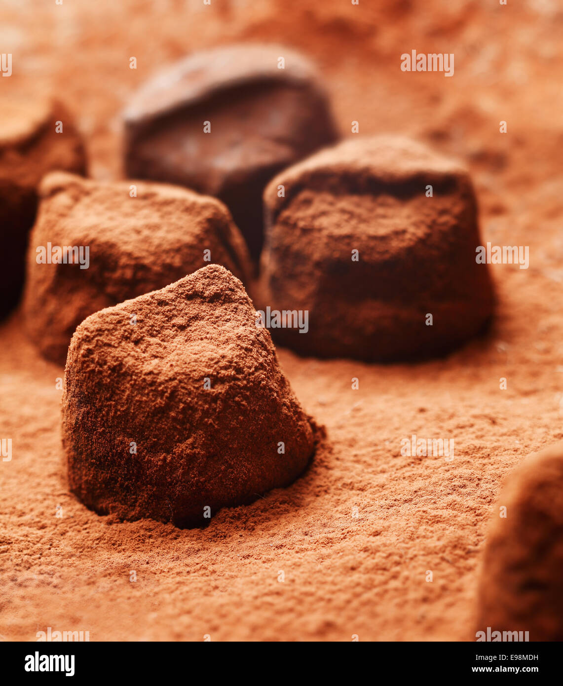 Chocolate pieces of irregular sizes covered in cocoa powder Stock Photo ...