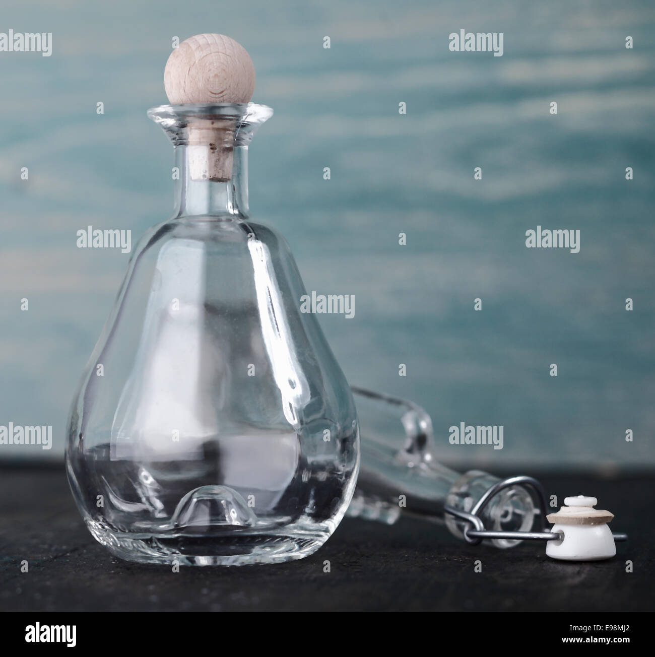 Decorative empty conical glass decanter with a round wooden stopper ...