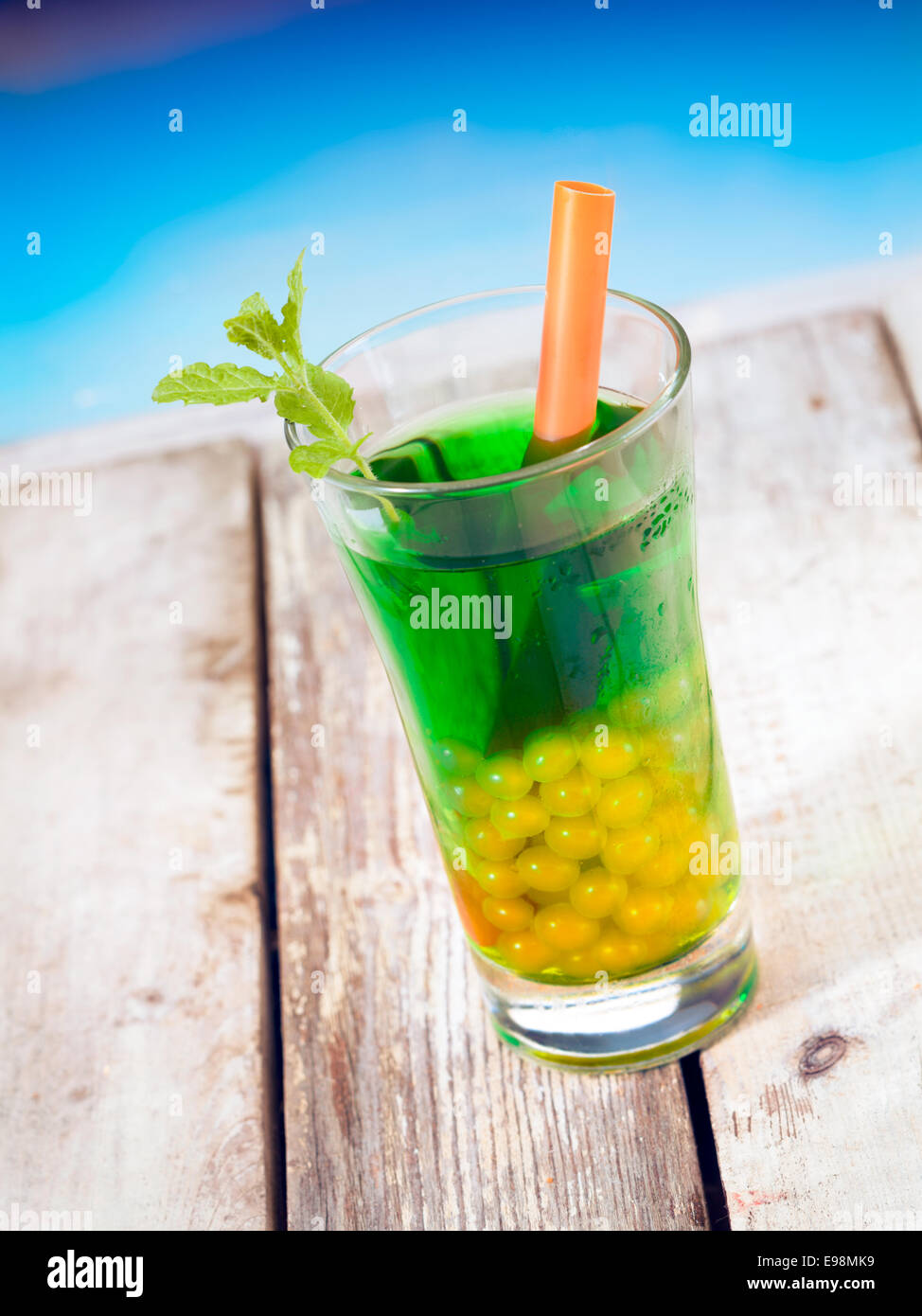 Boba Tea standing on wooden planks in front of the ocean Stock Photo ...