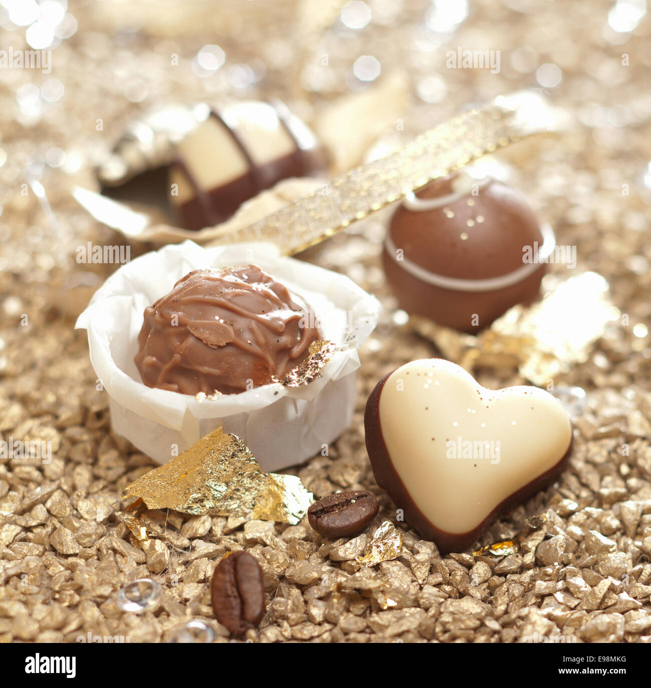 Handmade luxury chocolates with focus to a chocolate heart truffle in ...