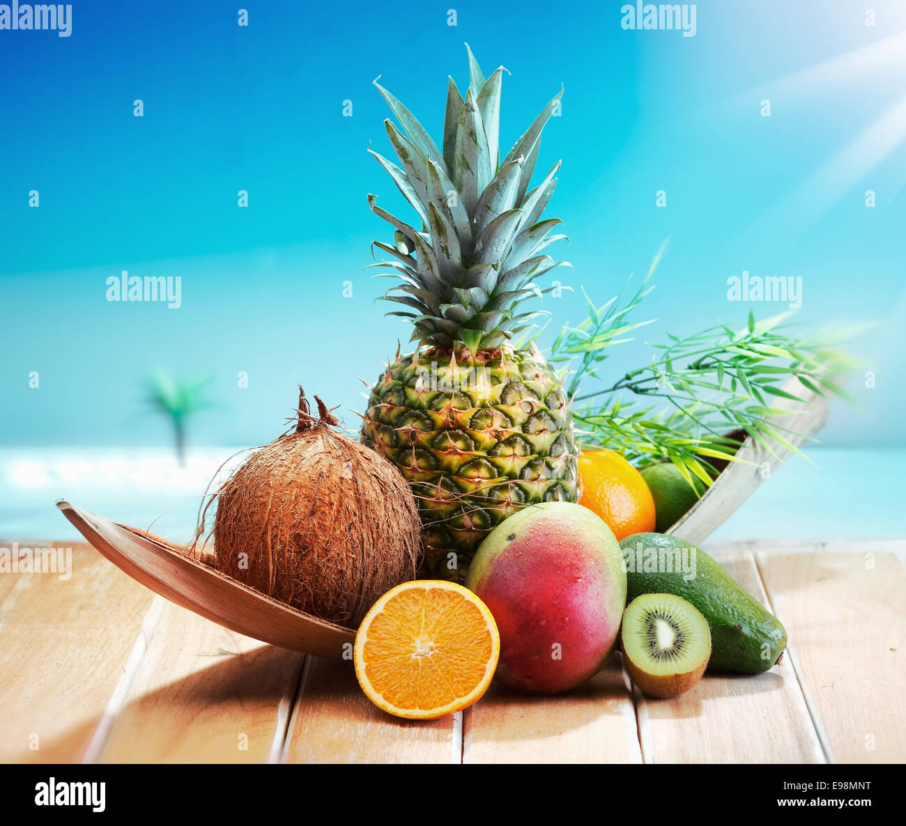 Fresh Fruits on the beach at a deck in front of an island with a palm ...