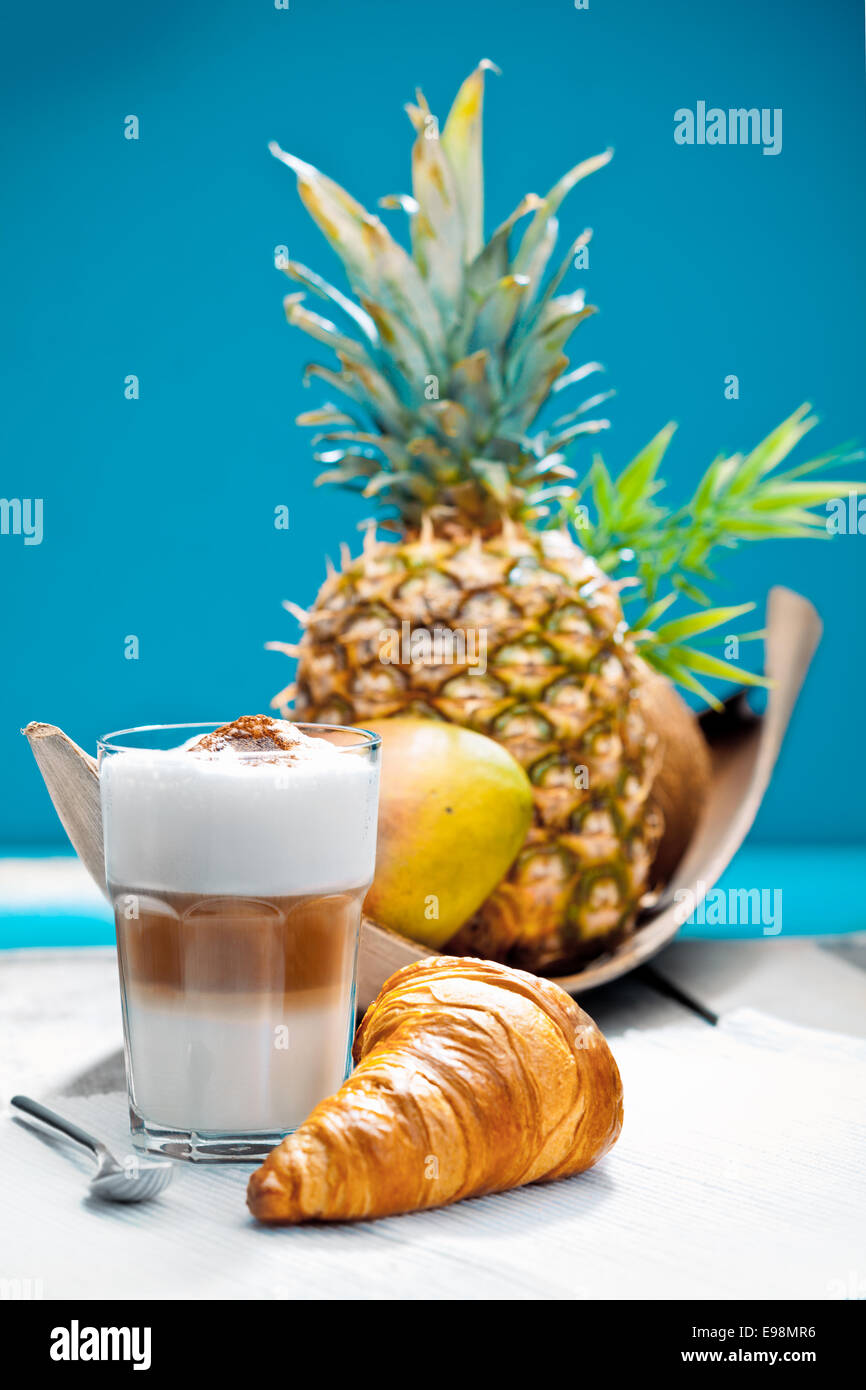 Coffee Break on a deck at the beach with a croissant and tropical ...