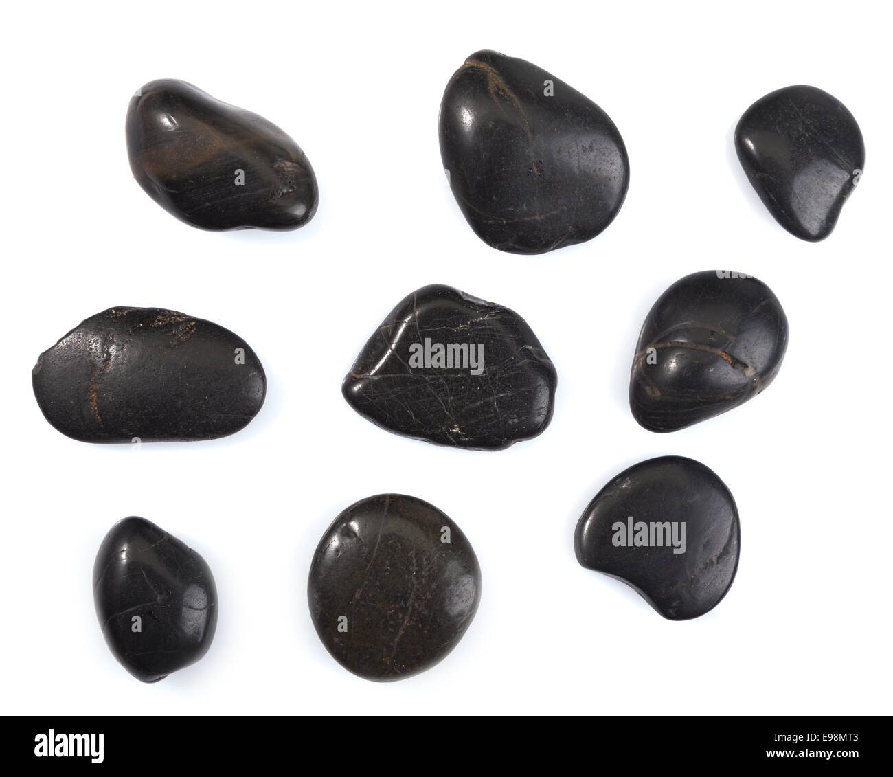 Collection of black massage stones as used in a spa hot rock pampering ...