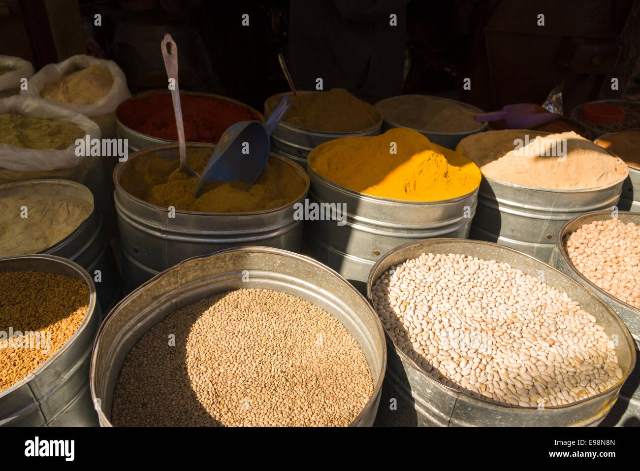 Large containers with exotic spices and pulses at a stall in the souk ...