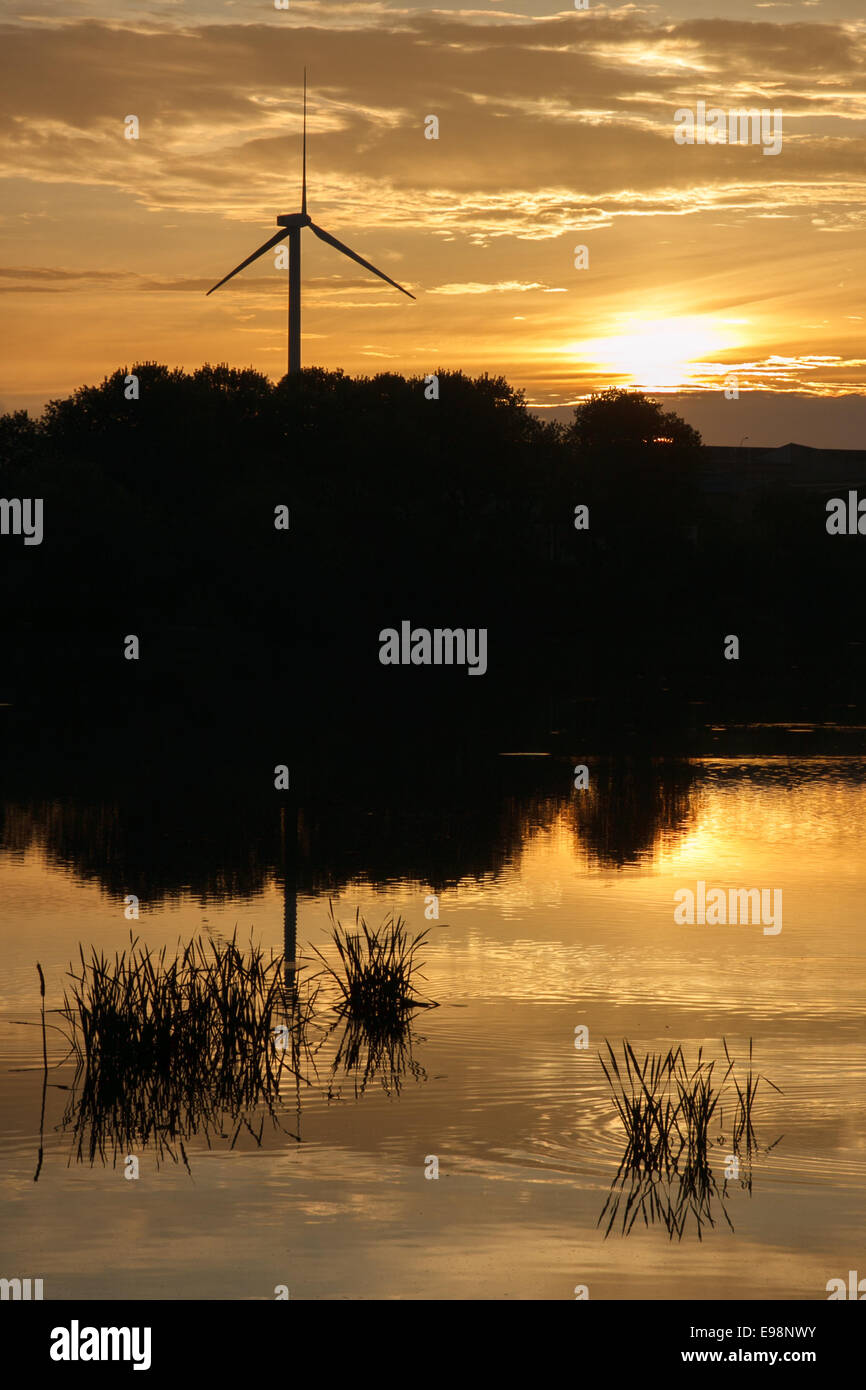Windmill at sunset on lake Stock Photo - Alamy