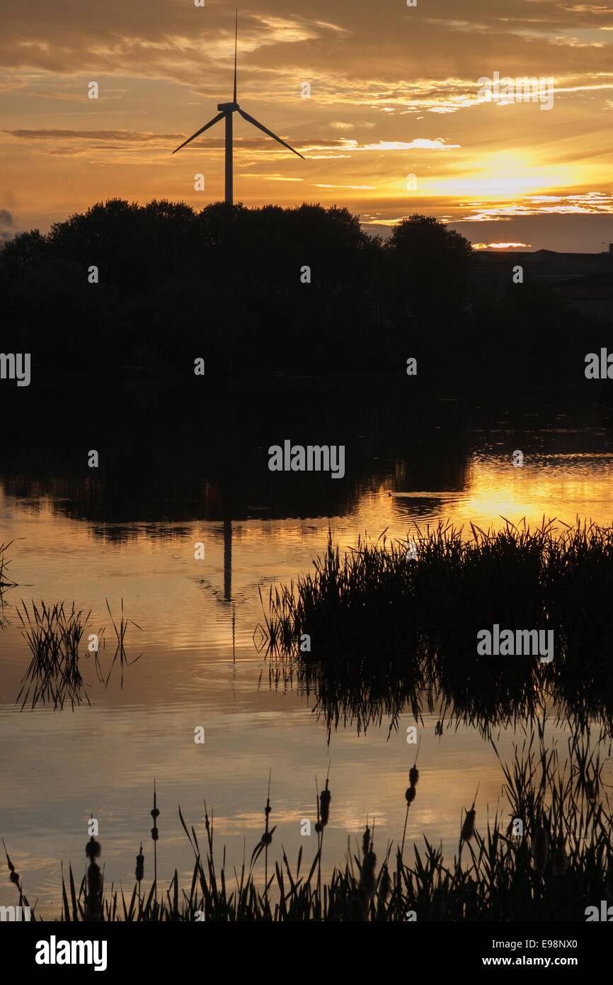 Windmill at sunset on lake Stock Photo - Alamy