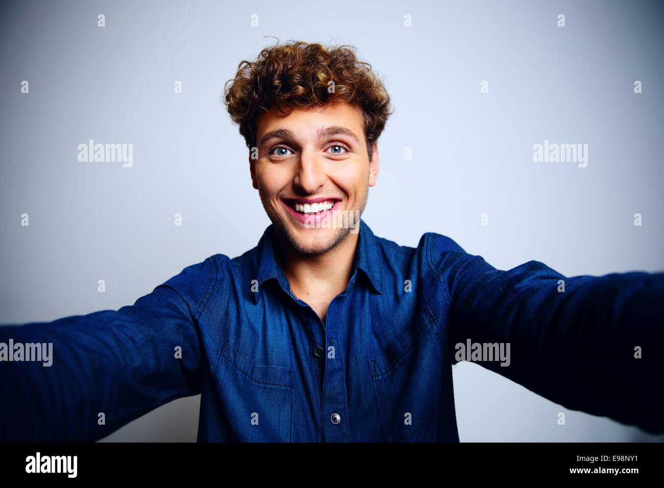 Portrait of a happy man over blue background Stock Photo - Alamy
