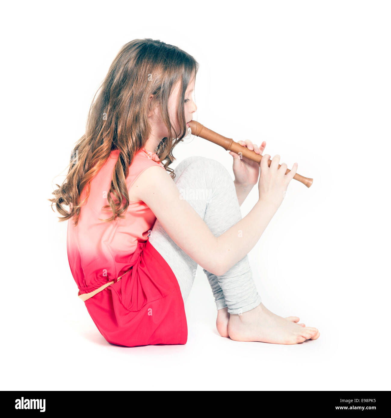 young girl sitting with soprano recorder and white background Stock ...