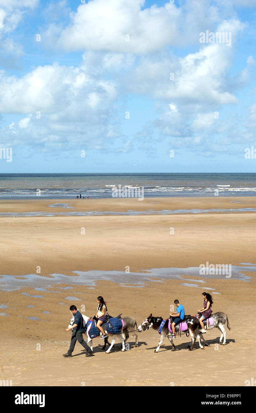 Riding donkeys on Blackpool beach Stock Photo - Alamy
