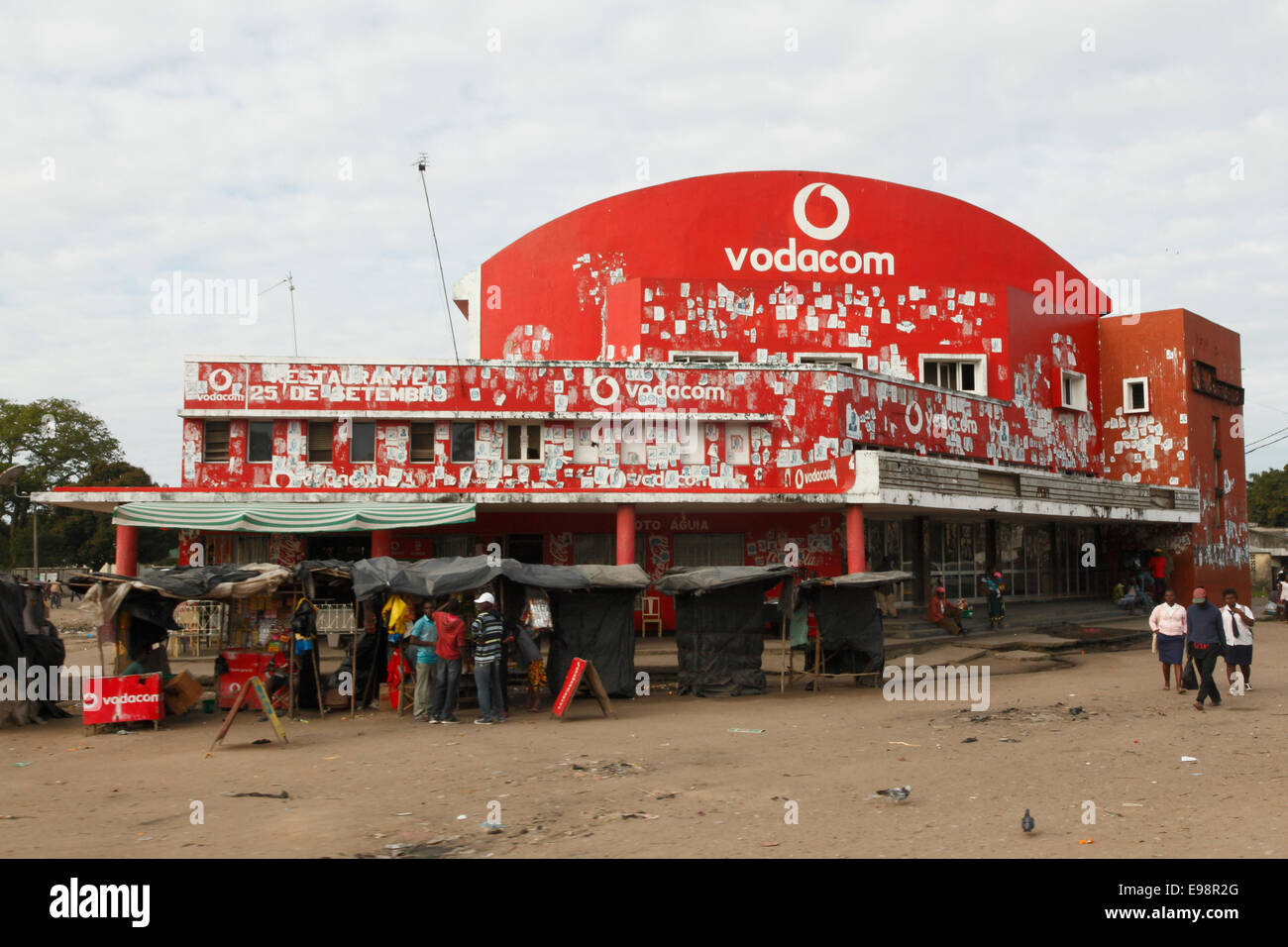 Building painted in red vodacom advertising and covered in election ...