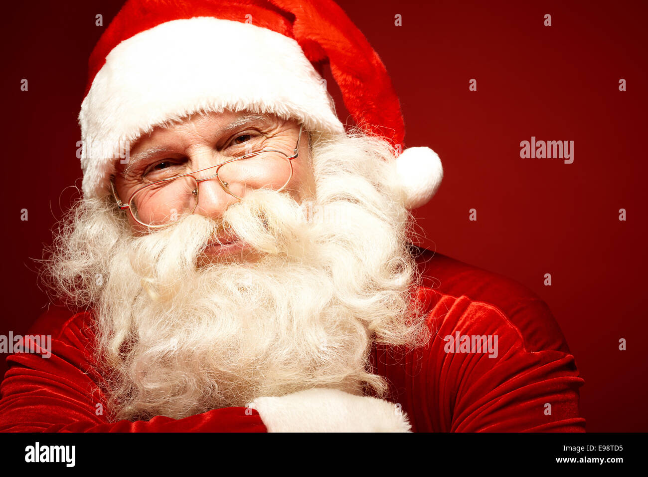 Positive Santa Claus in eyeglasses looking at camera with smile Stock ...