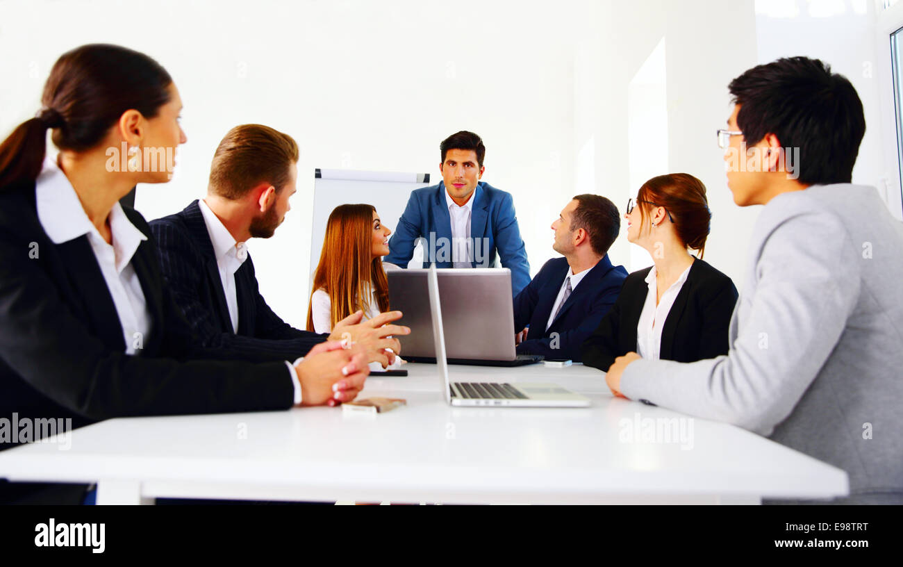 Businesspeople sitting at the table on a meeting Stock Photo - Alamy
