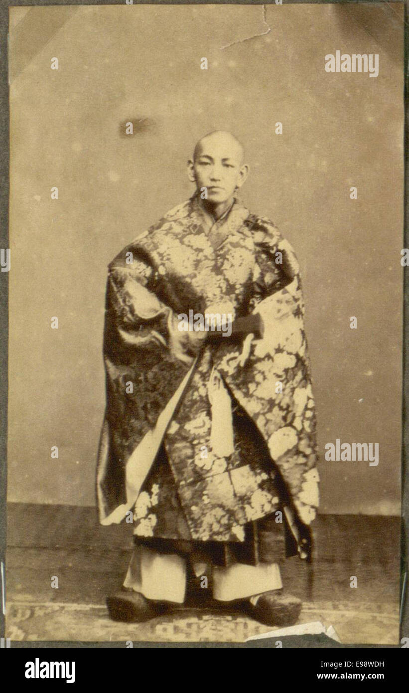 A photograph of a person wearing traditional Japanese ceremonial dress ...